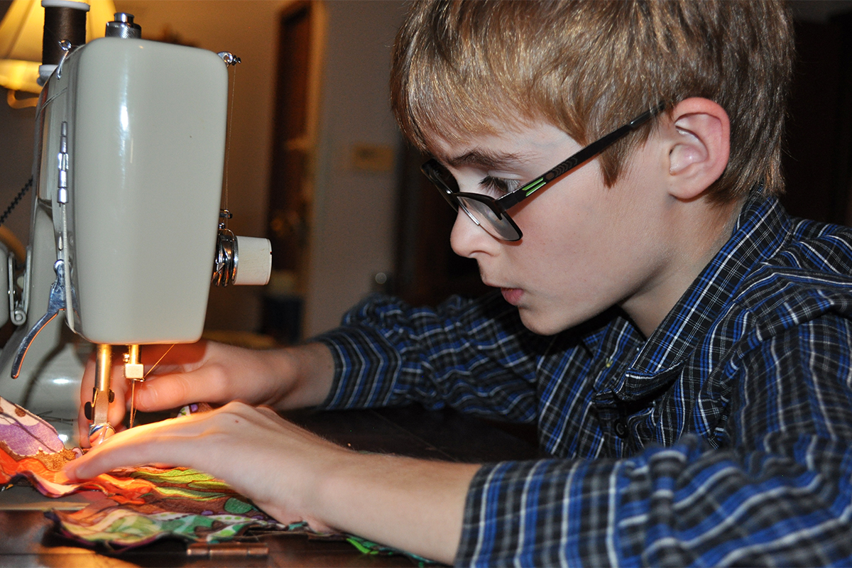 Young Boy Sews Bears for Children in Need