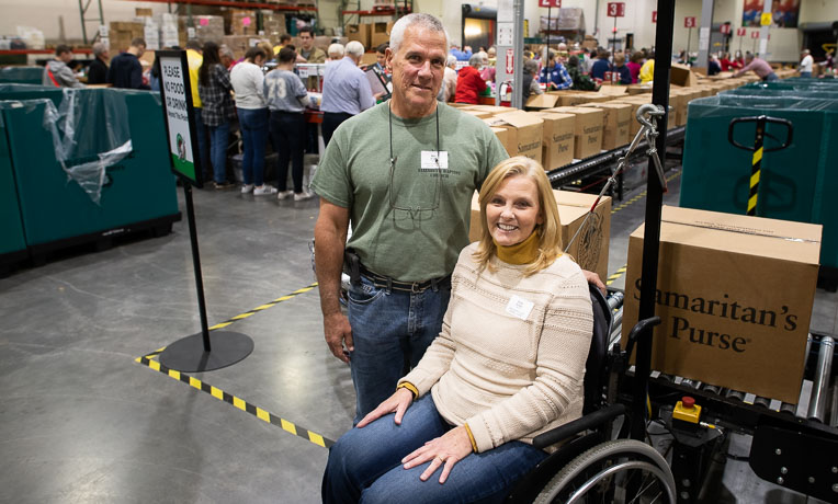 Paraplegic Volunteer Helps Process Shoeboxes for Children in Need